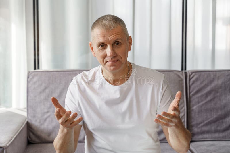 A Happy Middle-aged European Man Gestures with His Hands in Front of ...