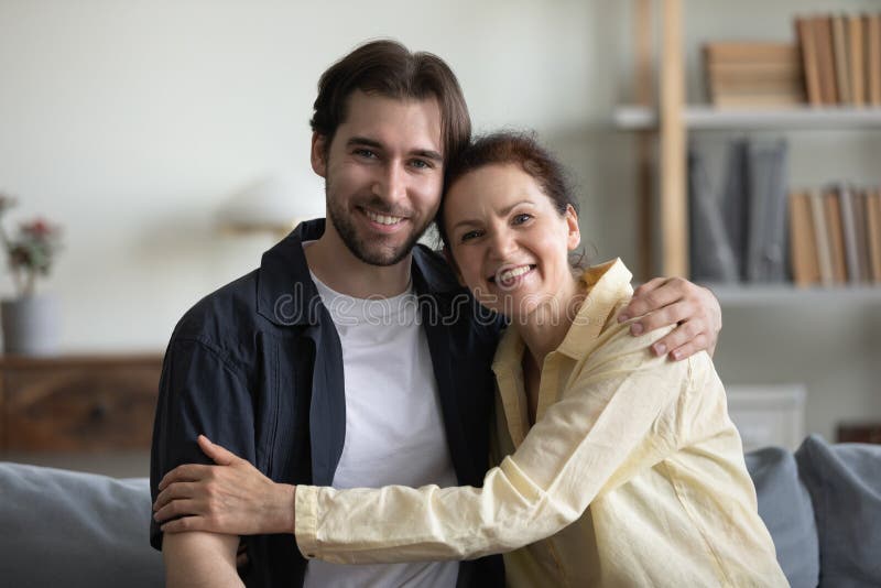 Happy Middle Aged Mother And Grown Son Hugging With Affection Stock