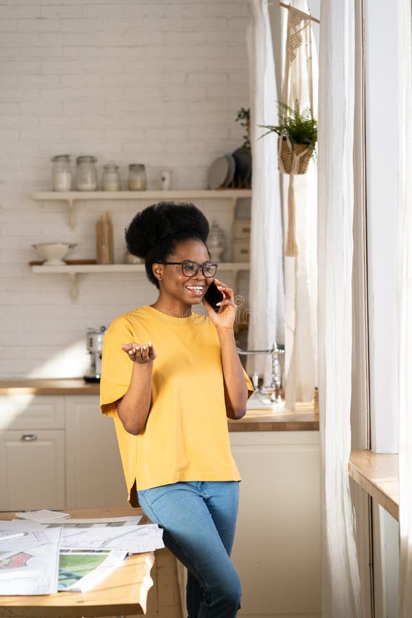 Happy Black Interior Designer Talk on Phone at Home Sit at Table with ...