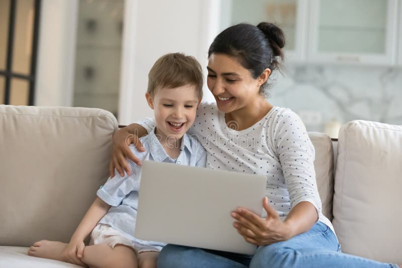 Happy Mixed Race Family Using Computer at Home. Stock Photo - Image of ...