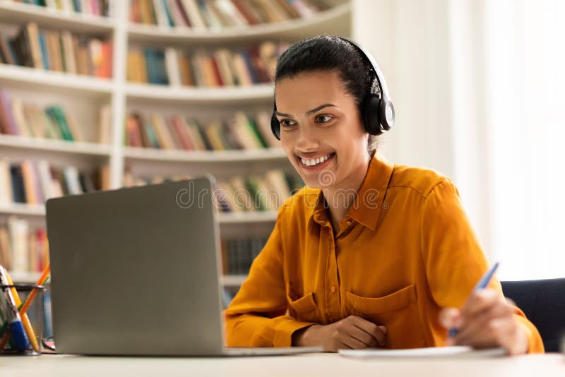 Happy Mixed Race Lady Having Online Class, Using Headset, Looking at ...