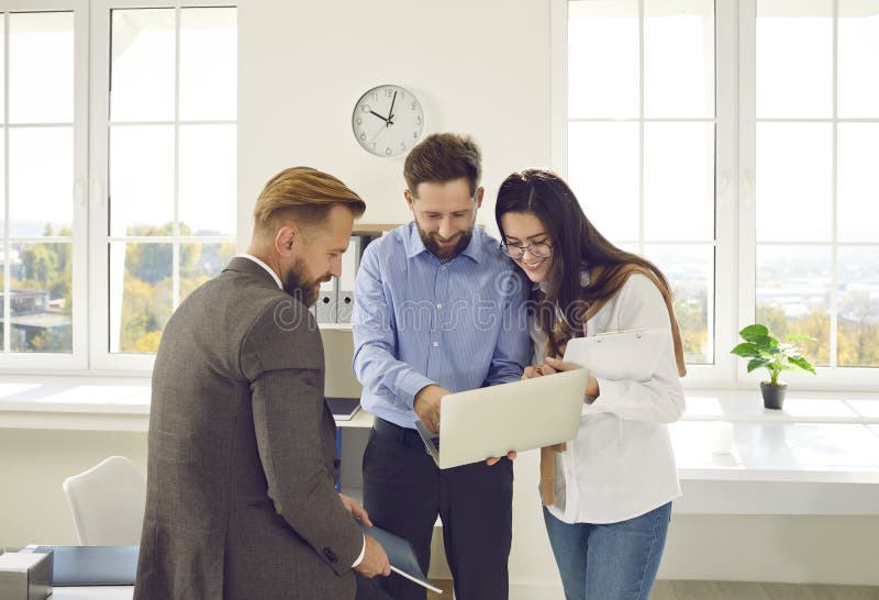 Happy Modern Business Team Using a Laptop PC while Working on a Project ...