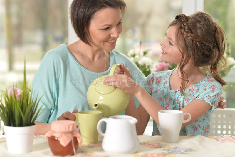 Happy Mom and Daughter Drinking Tea at Home Stock Photo - Image of ...
