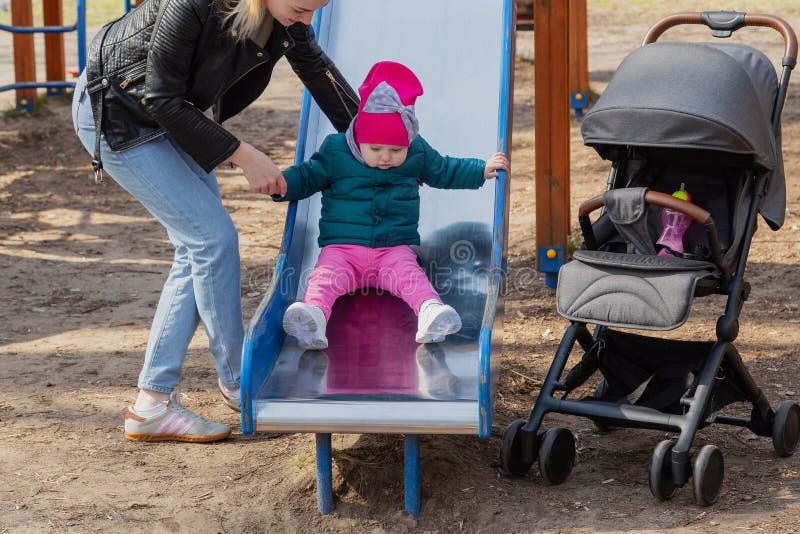 Happy Mom and Daughter Play on the Playground. Stock Image - Image of ...