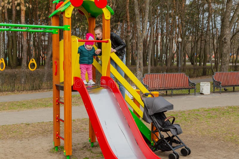 Happy Mom and Daughter Play on the Playground. Stock Photo - Image of ...