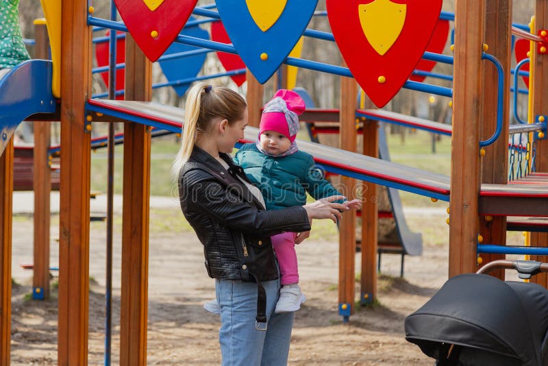 Happy Mom and Daughter Play on the Playground. Stock Photo - Image of ...