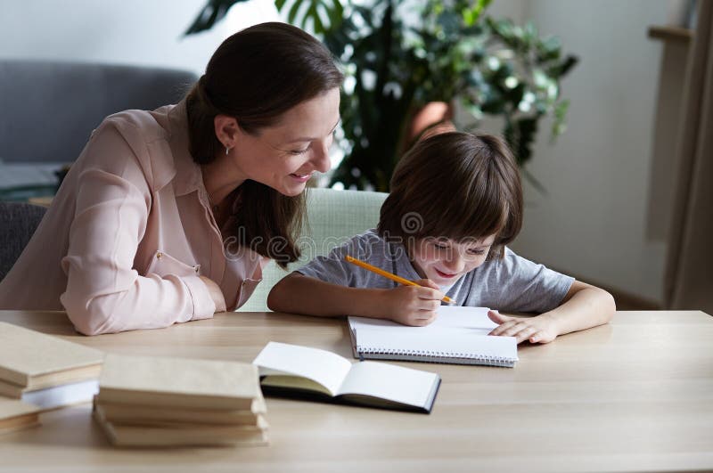 A Happy Mom Shows and Tells Her Son How To Solve a Difficult Math ...