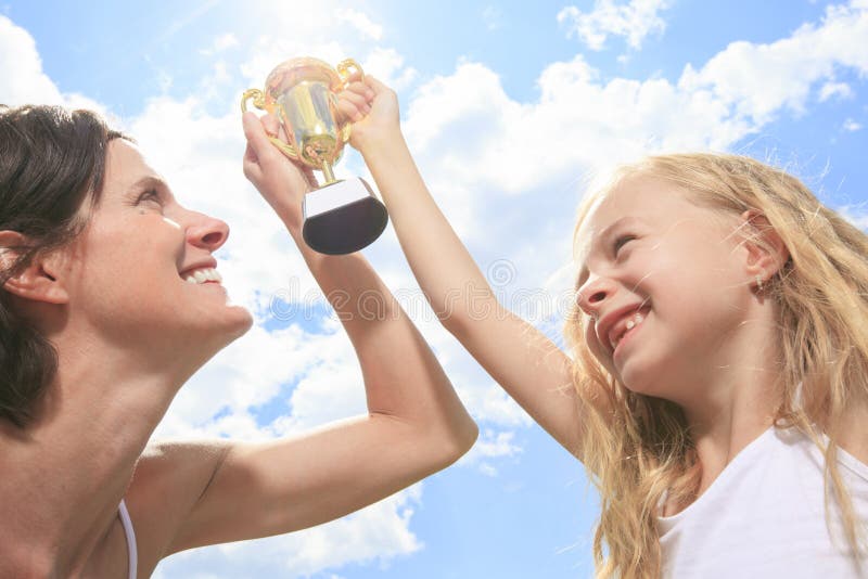 Happy Mother and Daughter Holding a Trophy High Up Stock Photo - Image ...