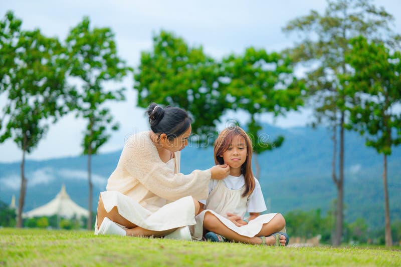 Happy Mother and Daughter Spending Time Together in a Park during ...