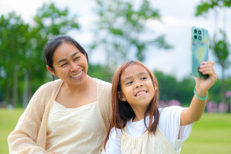Happy Mother and Daughter Spending Time Together in a Park during ...
