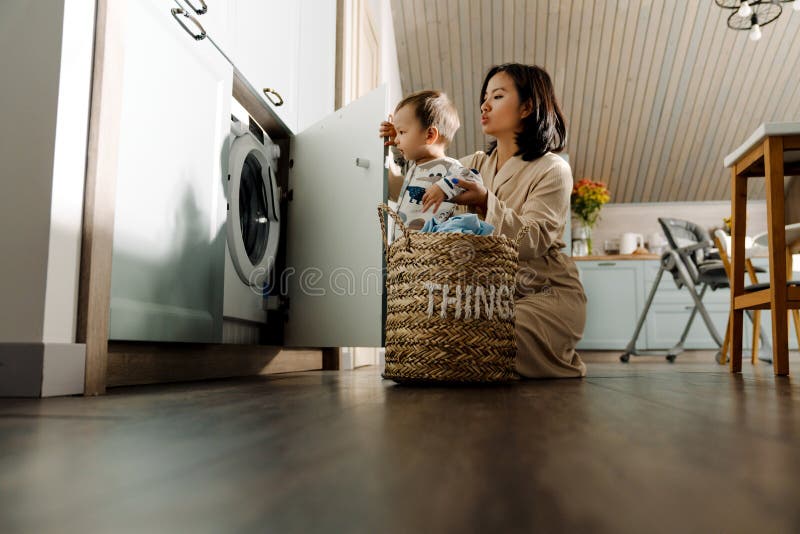 Happy Mother Doing Housework with Her Son with Her Son Stock Photo ...