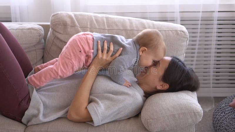 Mother With Son Lying Down And Using Laptop At Home Stock Video Video