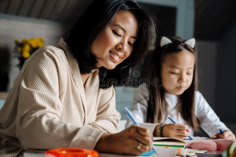 Happy Mother Smiling while Doing Homework with Her Mother Stock Photo ...