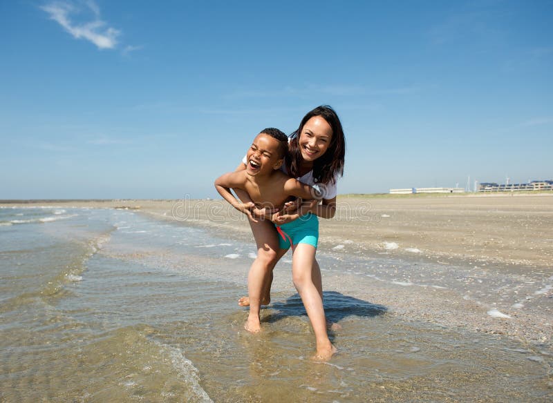 Happy Mother and Son Playing at the Beach Stock Image - Image of people ... Happy Mother and Son Playing at the Beach Stock Image - Image of people ...