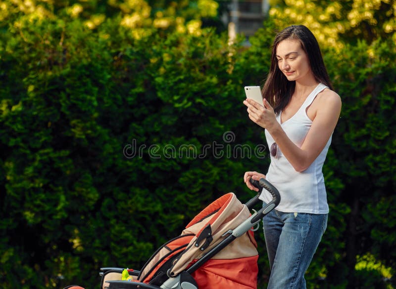 Happy mother with stroller stock photo. Image of family - 160336194