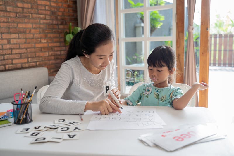 Mother Teaching Her Daughter the Basic To Read and Write Stock Image ... Mother Teaching Her Daughter the Basic To Read and Write Stock Image ...