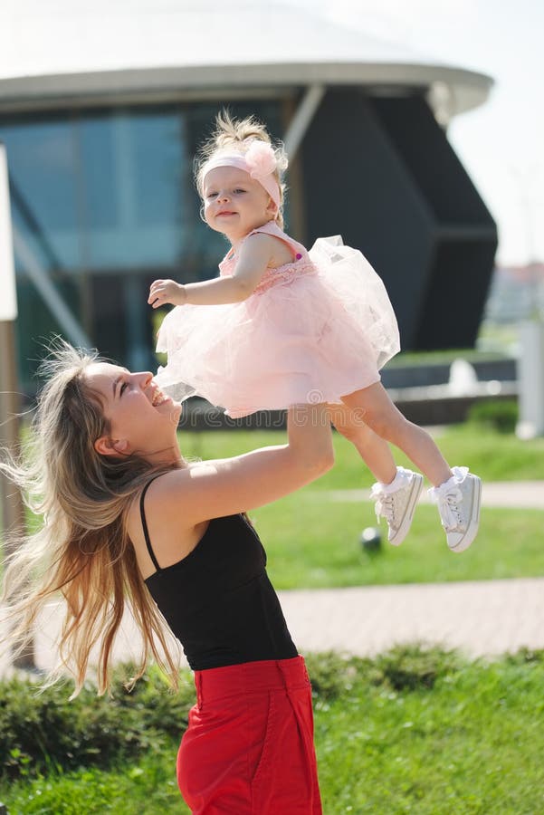 Happy Mother Throwing Up Her Little Daughter Stock Image - Image of ...