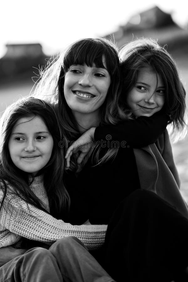 Portrait Of A Happy Young Woman With Her Daughter On The Beach At