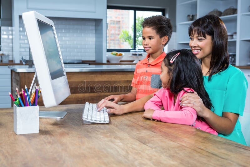 Happy Mother Using Computer with Her Children Stock Photo - Image of ...