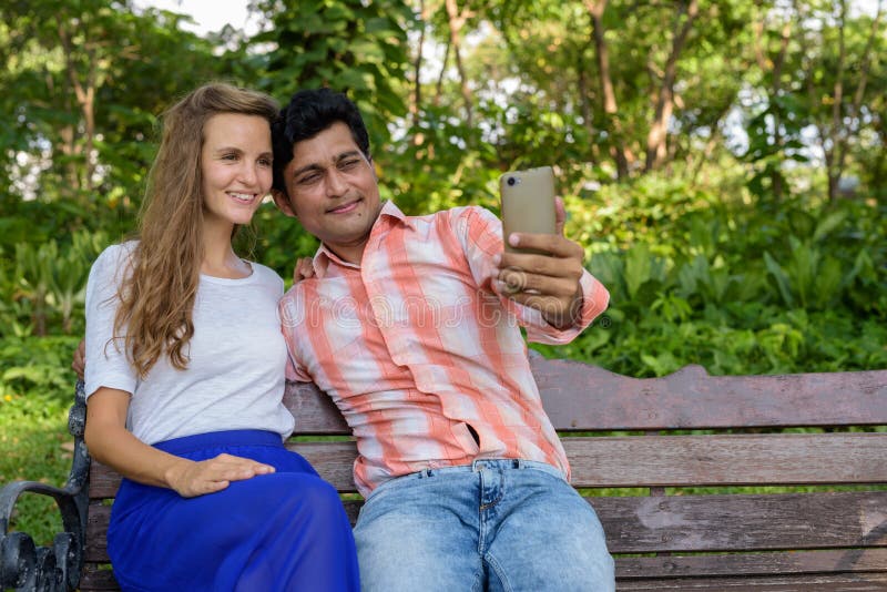 Happy Multi Ethnic Couple Smiling And In Love While Taking Selfi Stock