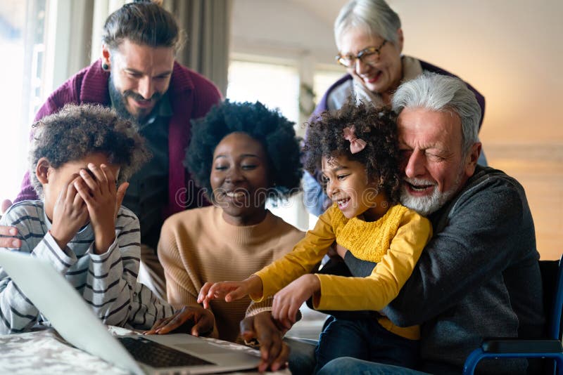 Happy Multi-generation Family Gathering Around Notebbok and Having Fun ...
