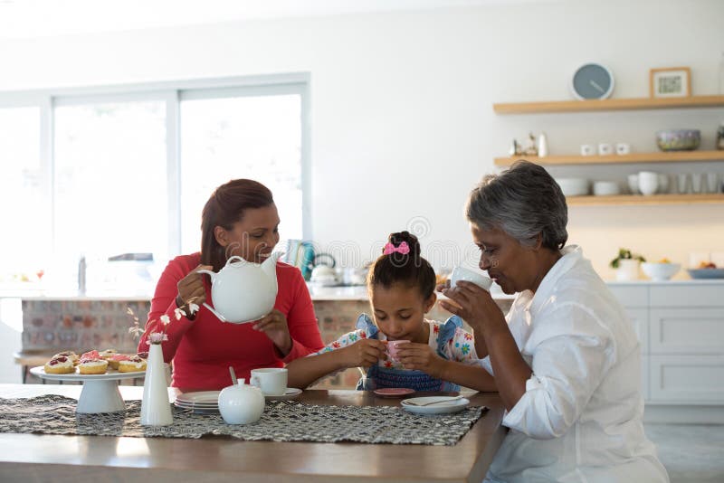 Happy Multi-generation Family Having Tea in Dining Table Stock Image ...