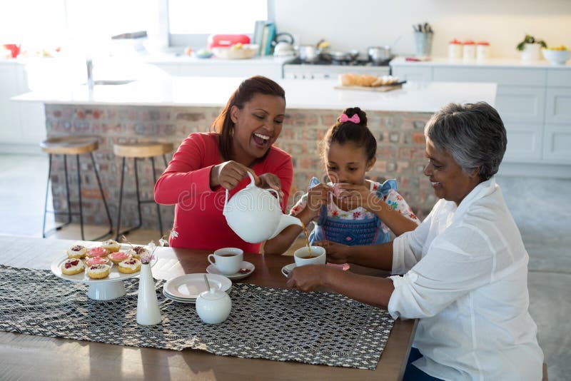 Happy Multi-generation Family Having Tea in Dining Table Stock Image ...
