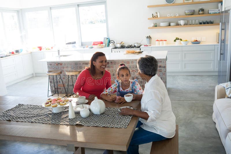 Happy Multi-generation Family Having Tea in Dining Table Stock Photo ...