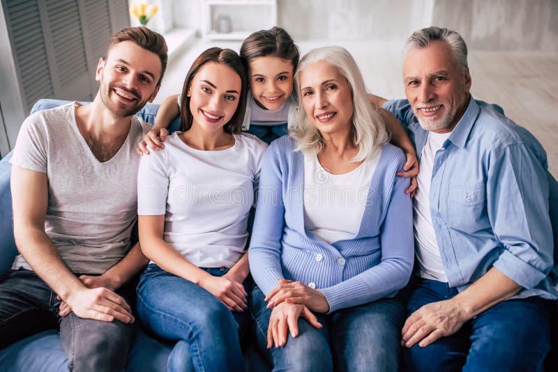 The Happy Multi Generation Family Sitting on the Sofa. Stock Photo ...