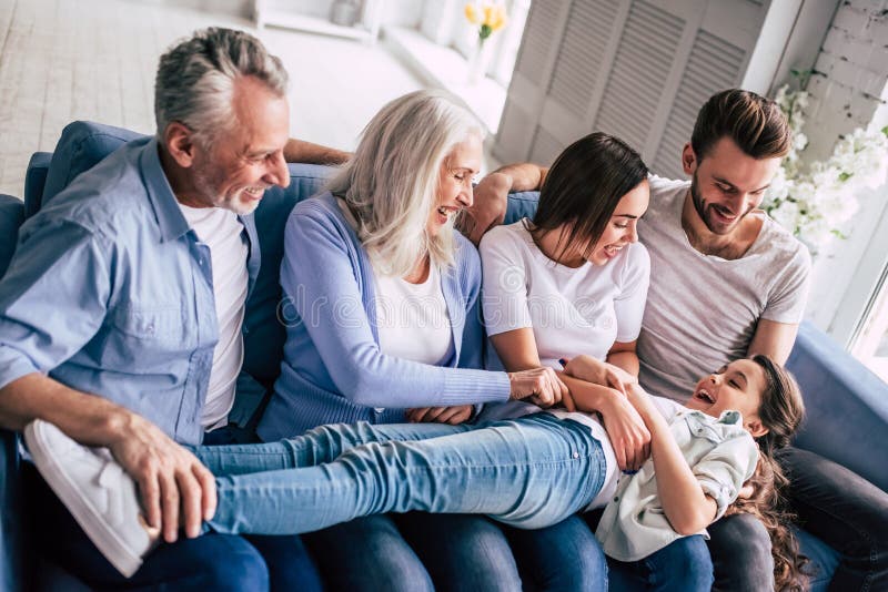 The Happy Multi Generation Family Sitting on the Sofa. Stock Photo ...