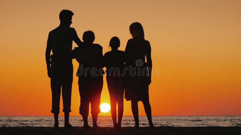 Happy Multi-generational Family Enjoying Sunset Over the Sea Stock ...