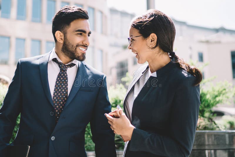 Happy Multicultural Man and Woman in Formal Wear Communicate Outdoors ...