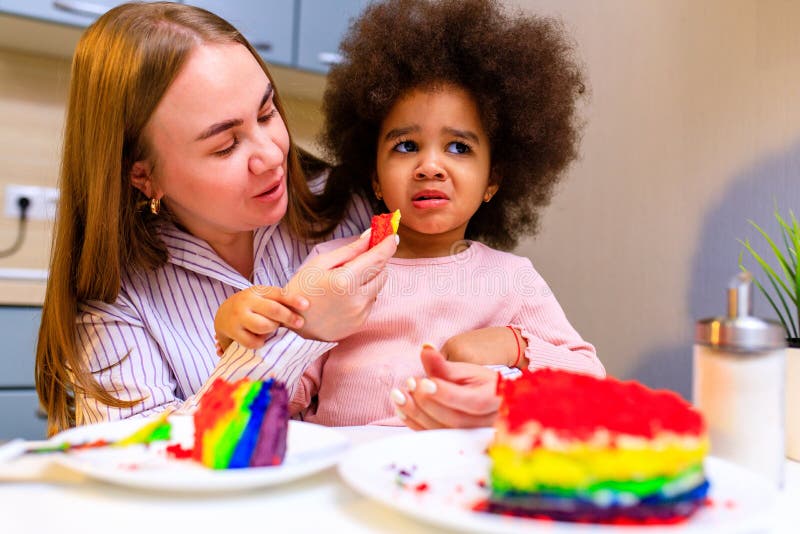Happy Multiethnic Family Eating Rainbow Cake at Kitchen Stock Photo ...