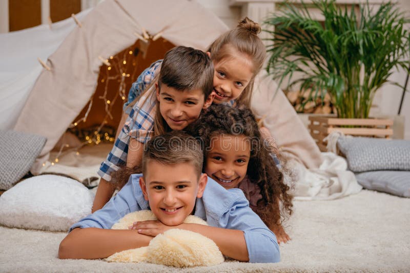 Happy Multiethnic Kids Lying in Pyramid Together at Home Stock Image ...