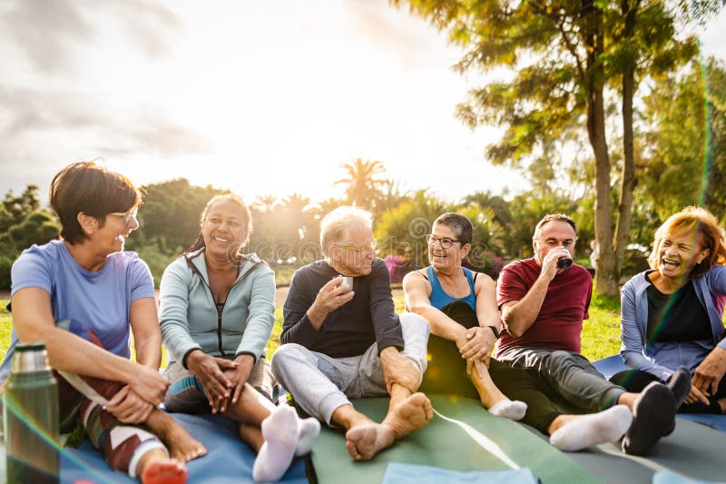 Happy Multiracial Senior Friends Drinking a Tea after Workout ...