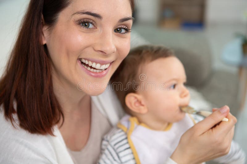 Happy Mum Spoon Feeding Child Son Indoors Stock Image - Image of ...