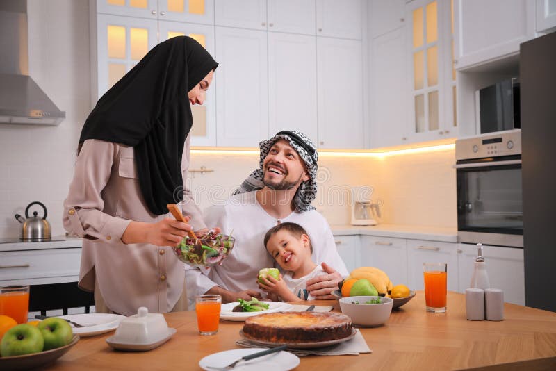 Happy Muslim Family Eating Together in Kitchen Stock Image - Image of ...