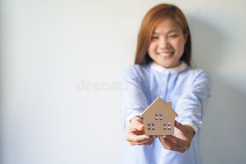 New Homeowner Holding Home Model in Her Hands Stock Photo - Image of ...
