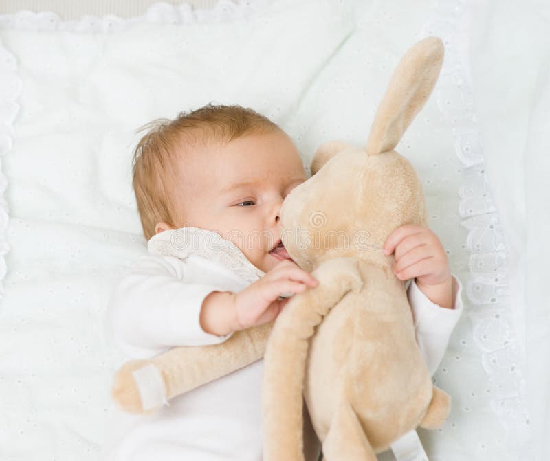 Happy Newborn Baby Plays with Toy Rabbit Stock Photo - Image of ...
