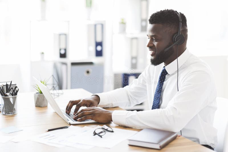 Happy Office Worker at Laptop Sitting at Work Desk Indoors Stock Photo ...