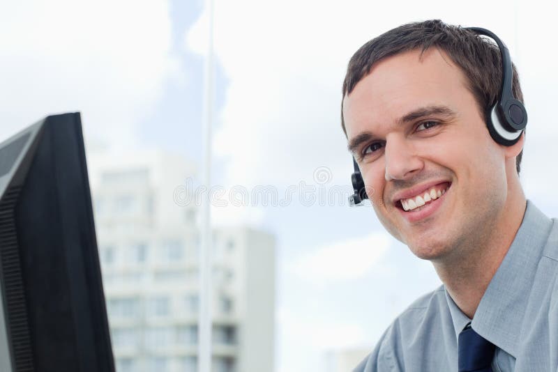 Happy Office Worker Using a Headset Stock Photo - Image of headset ...