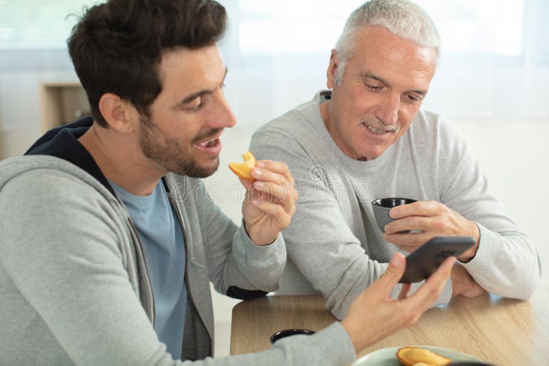 Happy Old Father Grown Son Watching Phone Stock Photos - Free & Royalty ...