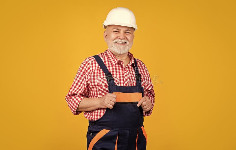 Happy Old Man Builder in Helmet on Yellow Background Stock Photo ...