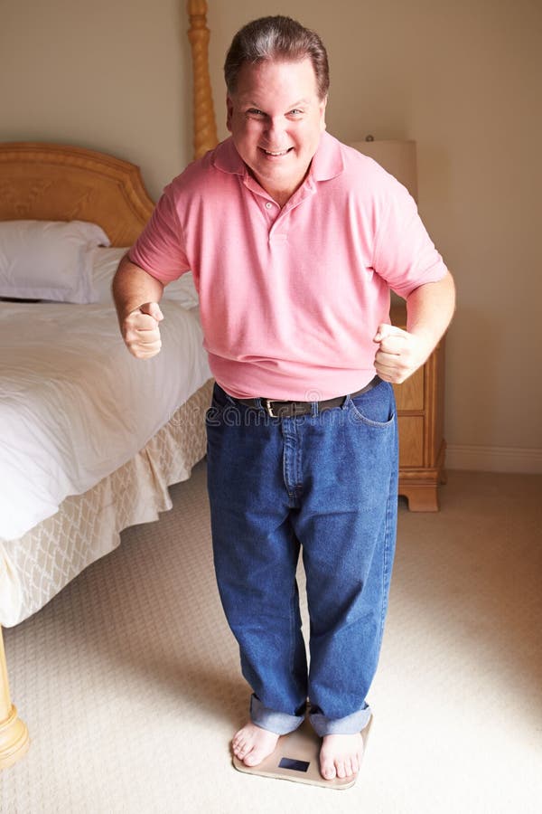 Happy Overweight Man Standing on Scales in Bedroom Stock Image - Image ...