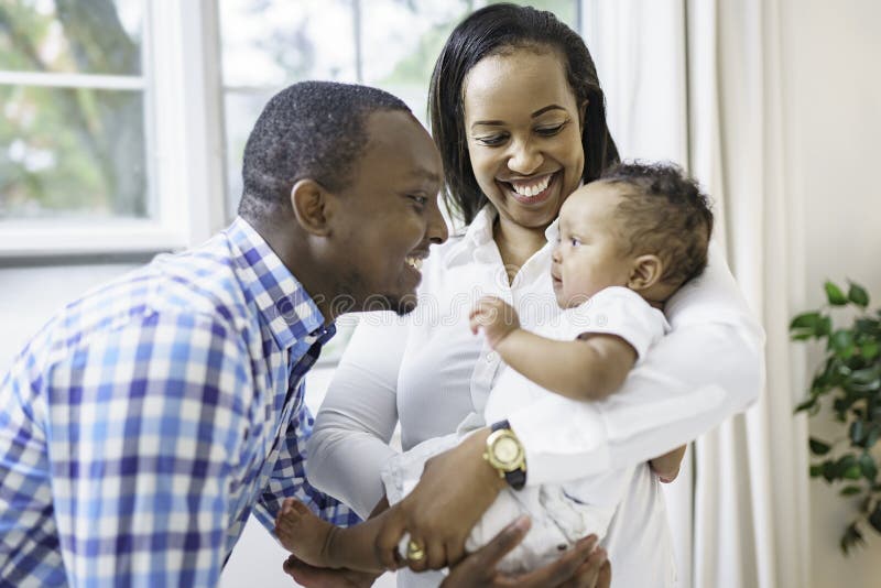 Happy Parents with Baby Boy at Home in the Bedroom Stock Image - Image ...