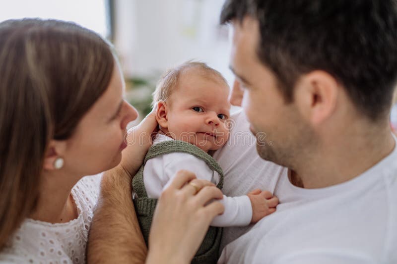 Happy Parents Cuddling with Their Newborn Baby. Stock Photo - Image of ...