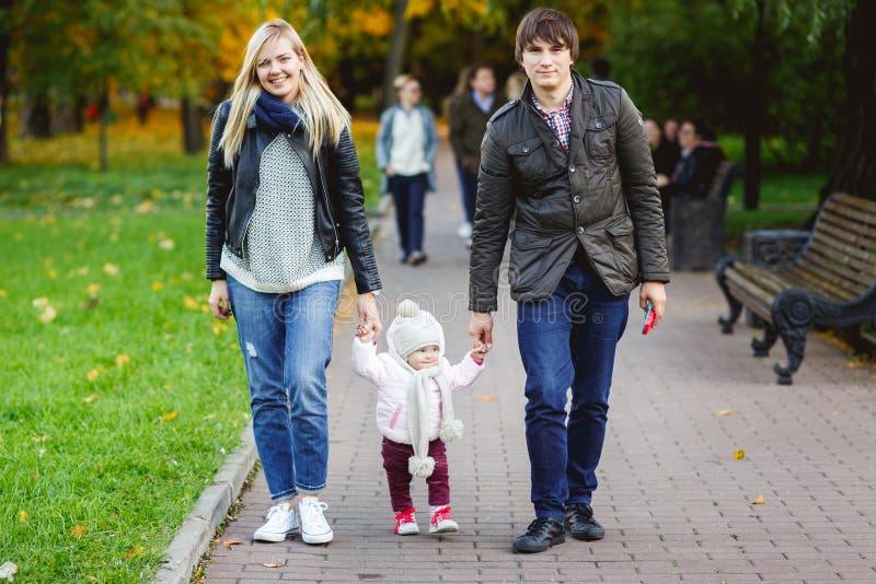 Happy Parents with Daughter Going on Path in Park Stock Photo - Image ...