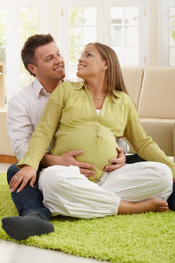 Expecting Parents with Baby Shoes Stock Photo - Image of couple, cosy ...