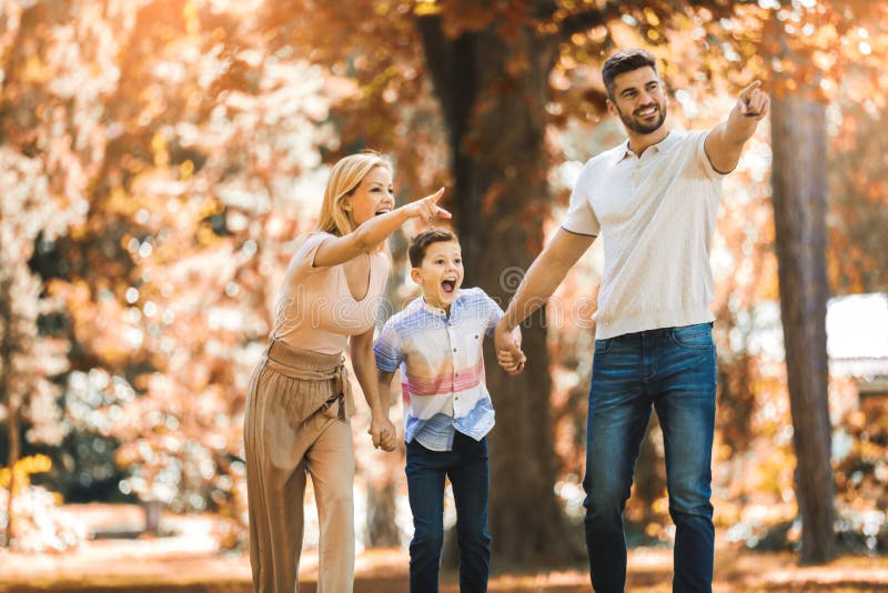 Parents Have Fun with Their Son in Autumn Park. Selective Focus Stock ...