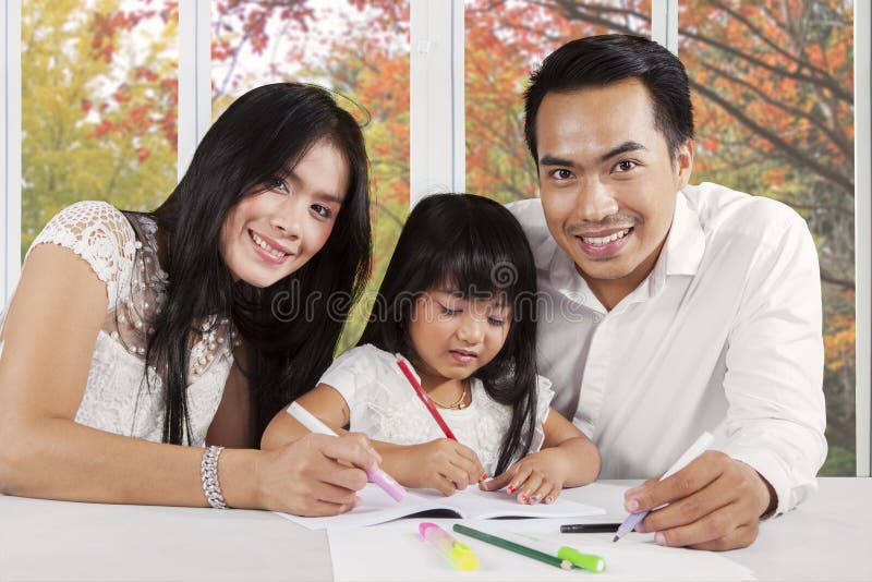Happy Parents Help Their Child Studying Stock Photo - Image of book ...